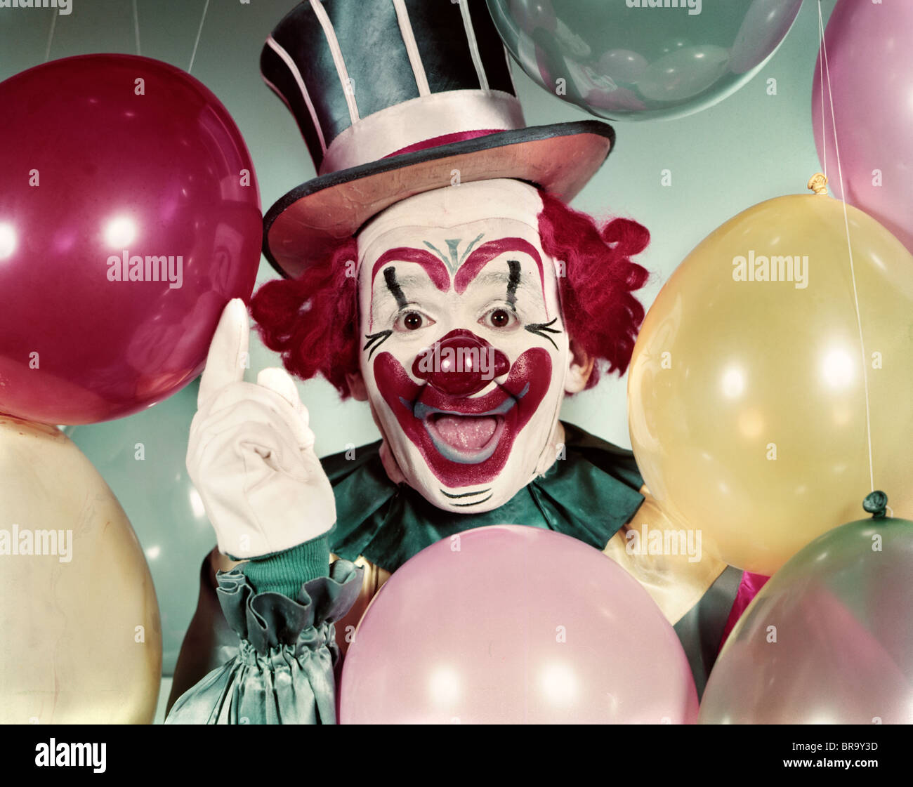 1950s CIRCUS CLOWN PORTRAIT SMILING AMID BALLOONS POINTING UP LOOKING ...
