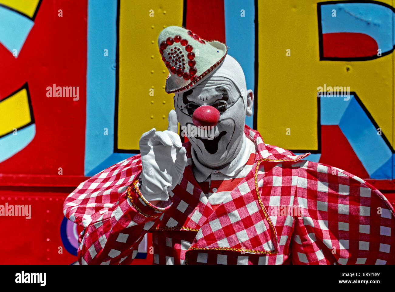 1970s WHITE FACED CLOWN IN RED CHECKED JACKET HOLDING UP GLOVED HAND ...