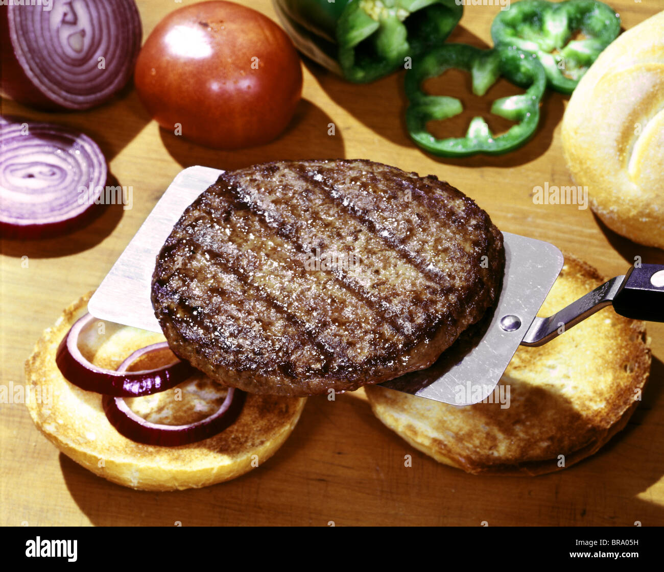 HAMBURGER BEEF PATTY, ONION, TOMATOES & PEPPERS AND ROLLS Stock Photo ...