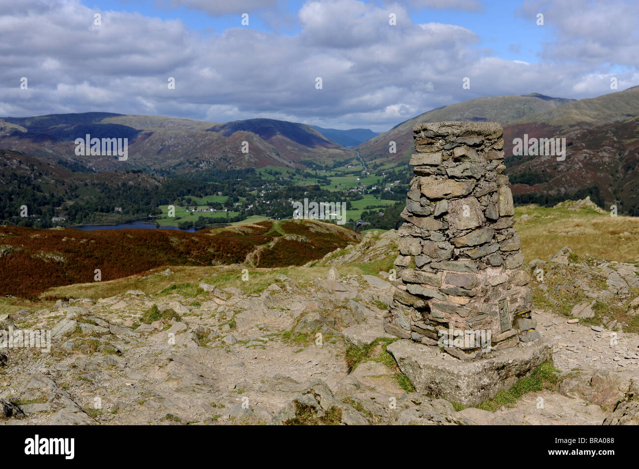 The trig point at the peak of Loughrigg Fell near Ambleside in The Lake ...