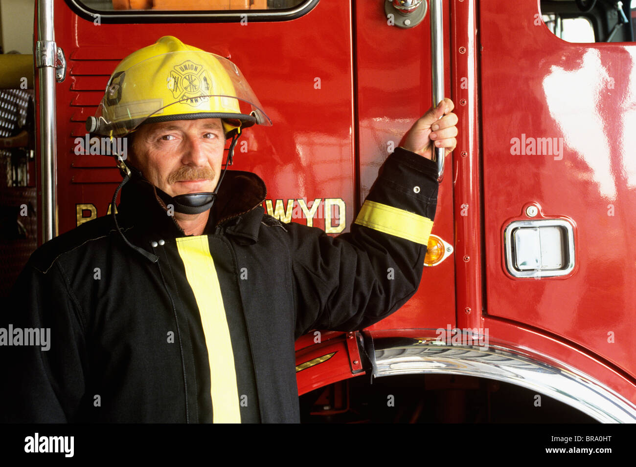 1990s PORTRAIT OF FIREMAN IN FULL GEAR BY TRUCK Stock Photo - Alamy