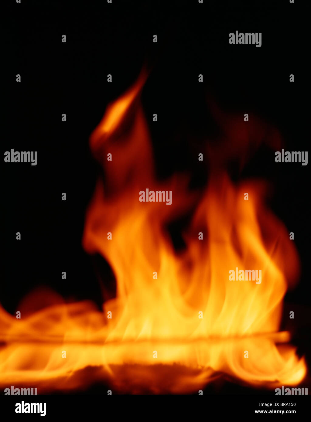 DETAIL OF ORANGE RED FLAMES OF A FIRE AGAINST BLACK BACKGROUND Stock ...