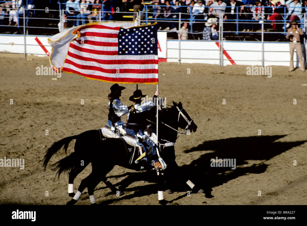 RODEO SCENE TWO RIDERS BLACK HORSES WITH AMERICAN FLAG Stock Photo - Alamy