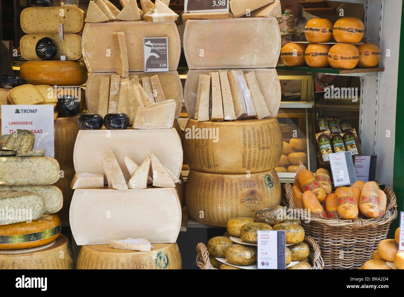 Netherlands, Amsterdam. Various cheeses on display in a store window ...