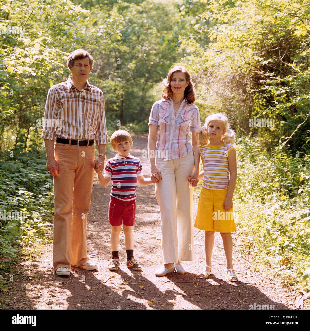 1970s FAMILY WALKING OUTDOORS FULL LENGTH MOTHER FATHER TWO KIDS MAN ...