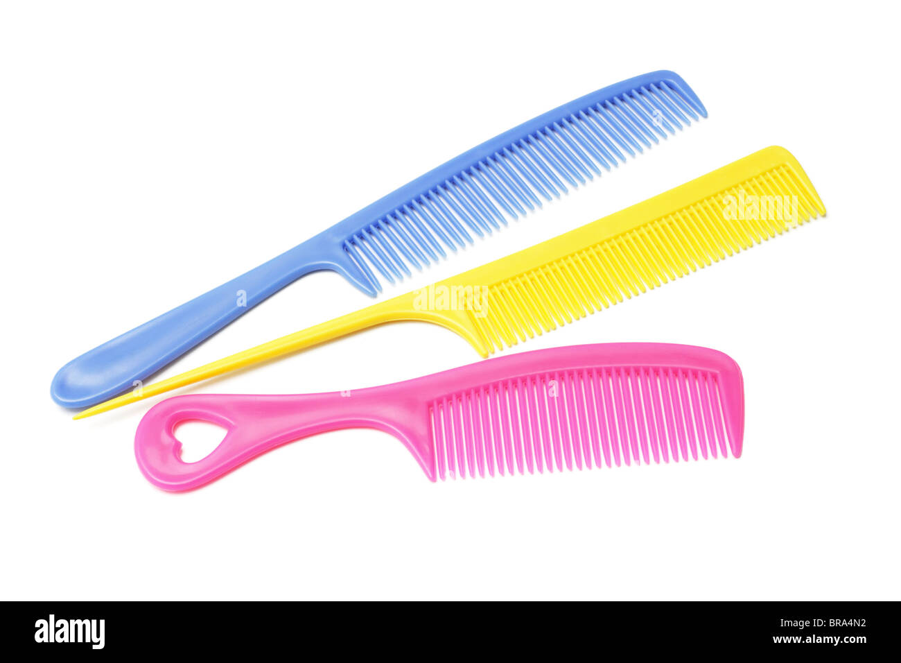 Three plastic combs with handles on white background Stock Photo - Alamy
