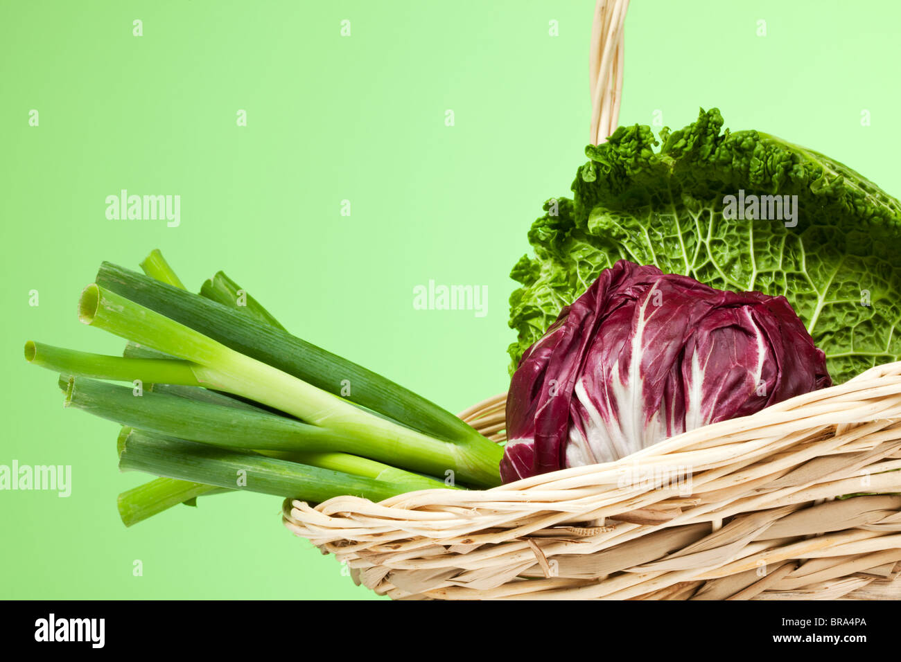 fresh vegetables in a basket, green background Stock Photo - Alamy