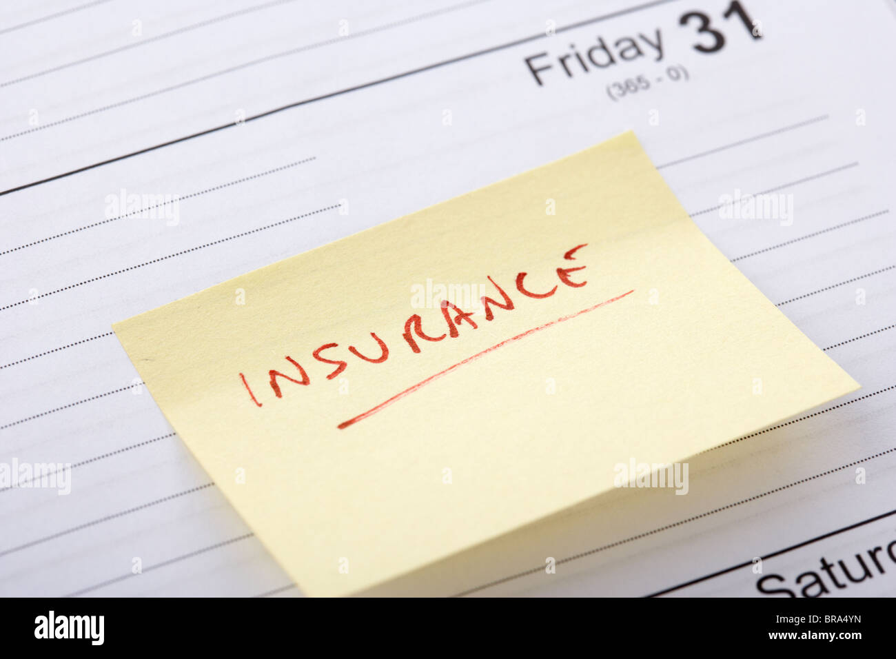 post-it note regarding insurance bill due stuck into a diary at the end ...