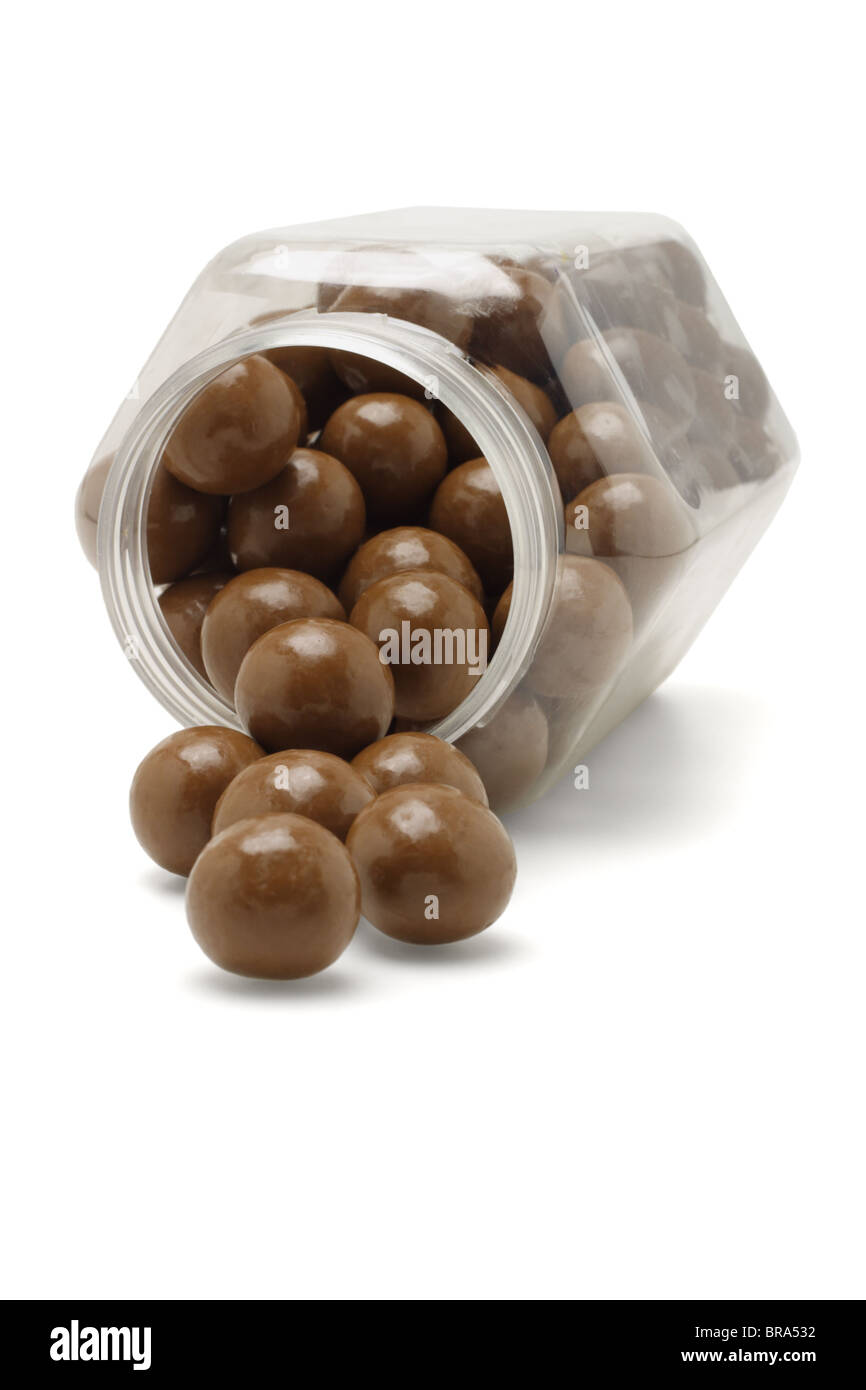 Chocolate balls spilling out from fallen plastic container Stock Photo ...