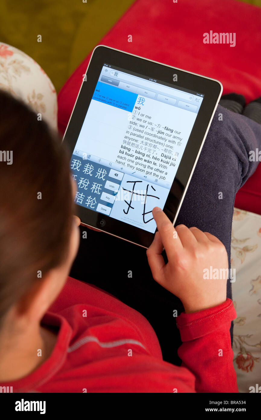 Female student learning mandarin Chinese using education application on ...