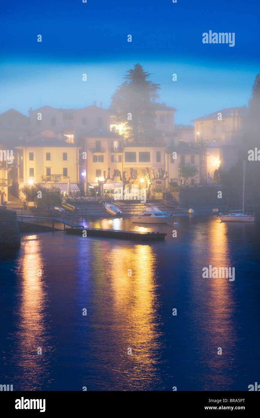Europe, Italy, Varenna. Misty evening dock scene on the shores of Lake ...