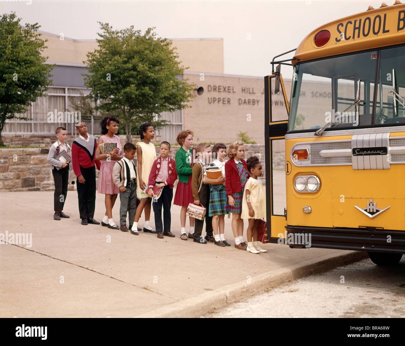 1960s GROUP OF KIDS IN LINE GETTING INTO SCHOOL BUS Stock Photo - Alamy