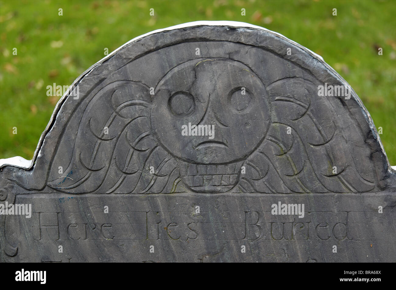 An old gravestone showing the deaths head Stock Photo - Alamy