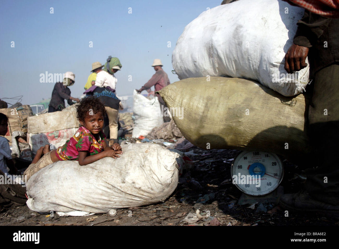 A young child laborer rests on a sack of garbage at The Stung Meanchey ...