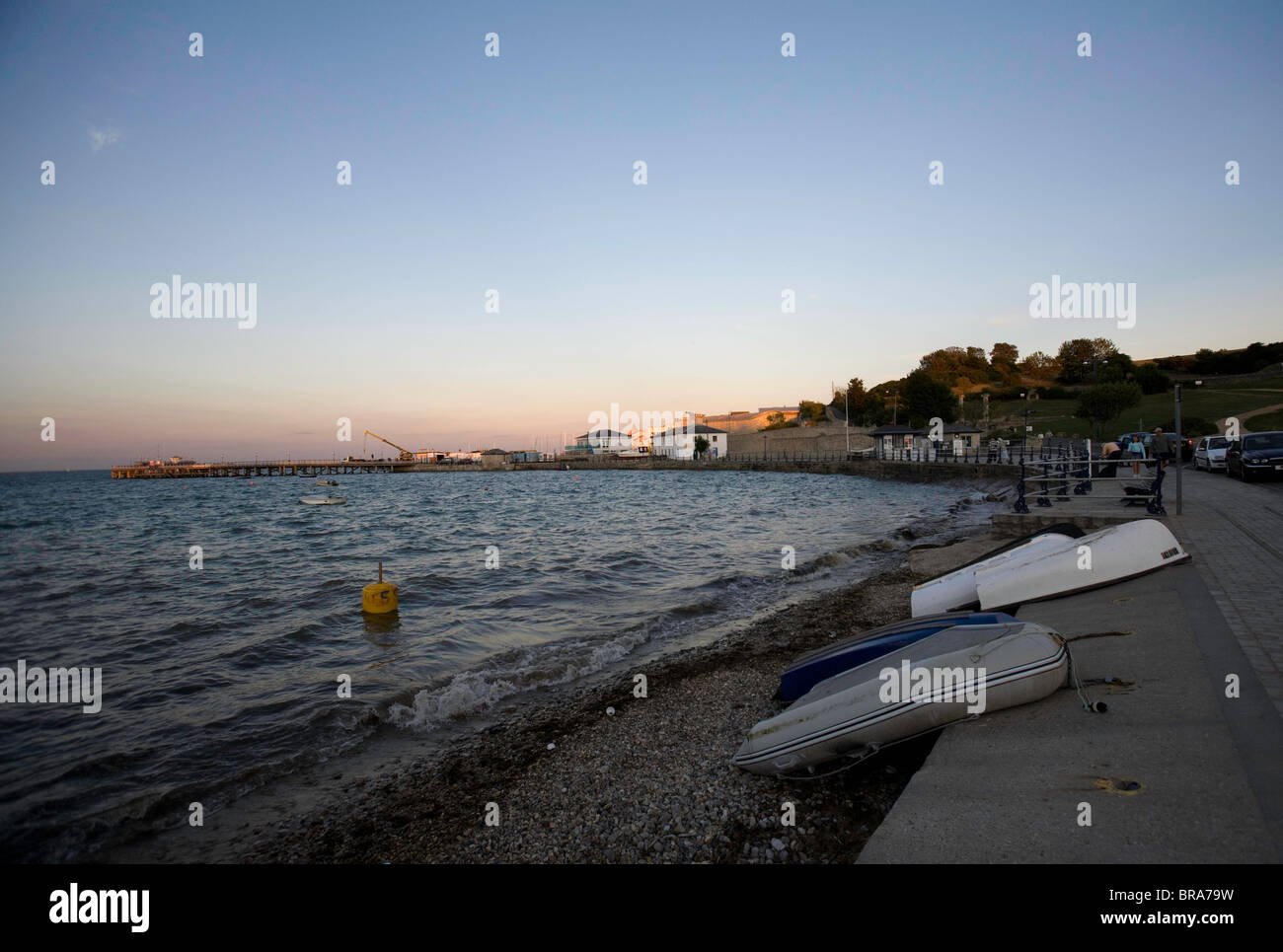 fishing boats upturned on the beach in the harbour at Swanage Stock ...