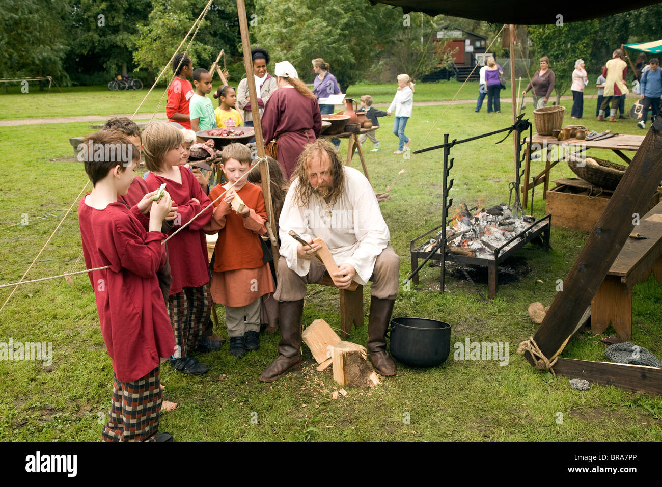 Man teaching children woodcraft, Historical re-enactment Saxon, Viking ...