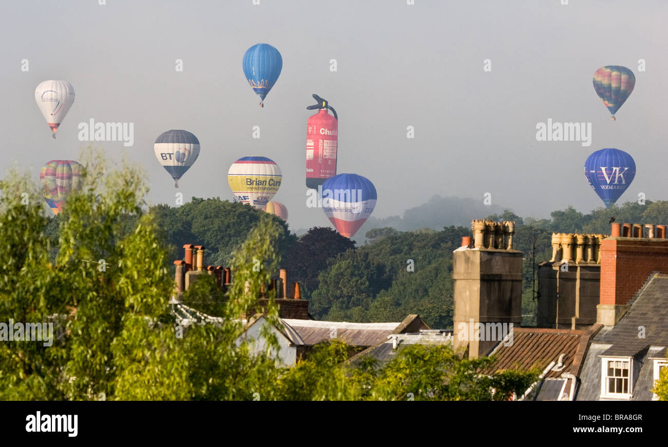 Motley collection of balloons taking off in morning mist from the ...