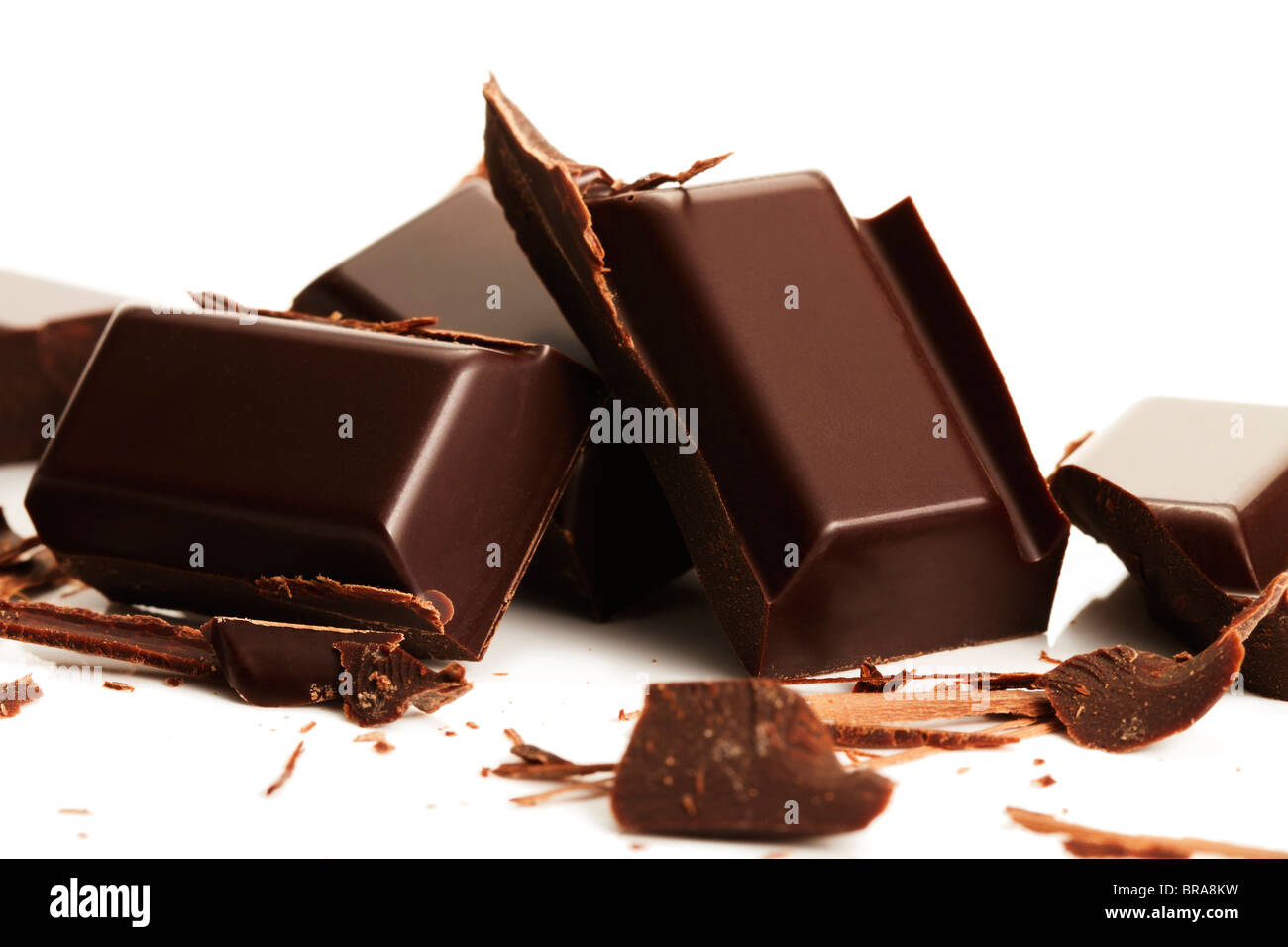 broken plain chocolate pieces on white background Stock Photo - Alamy