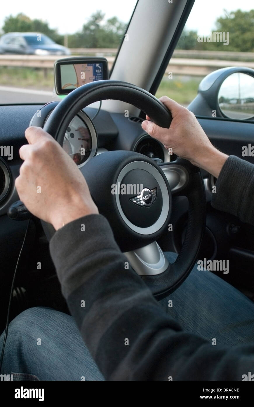 Driver with Hands on Steering Wheel Driving Car Stock Photo - Alamy