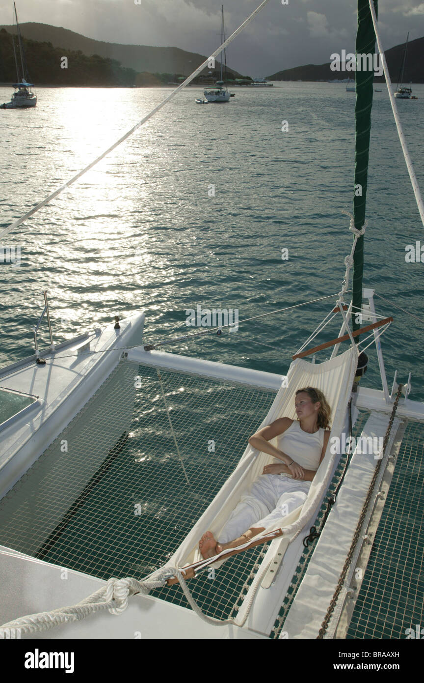 Woman relaxing in a hammock on Lagoon 470 Sunsail charter catamaran ...