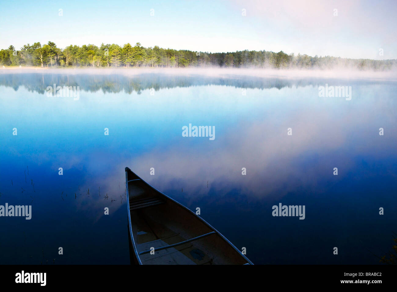 A canoe in the misty sunrise on Lake Dennison, Massachusetts, USA Stock ...