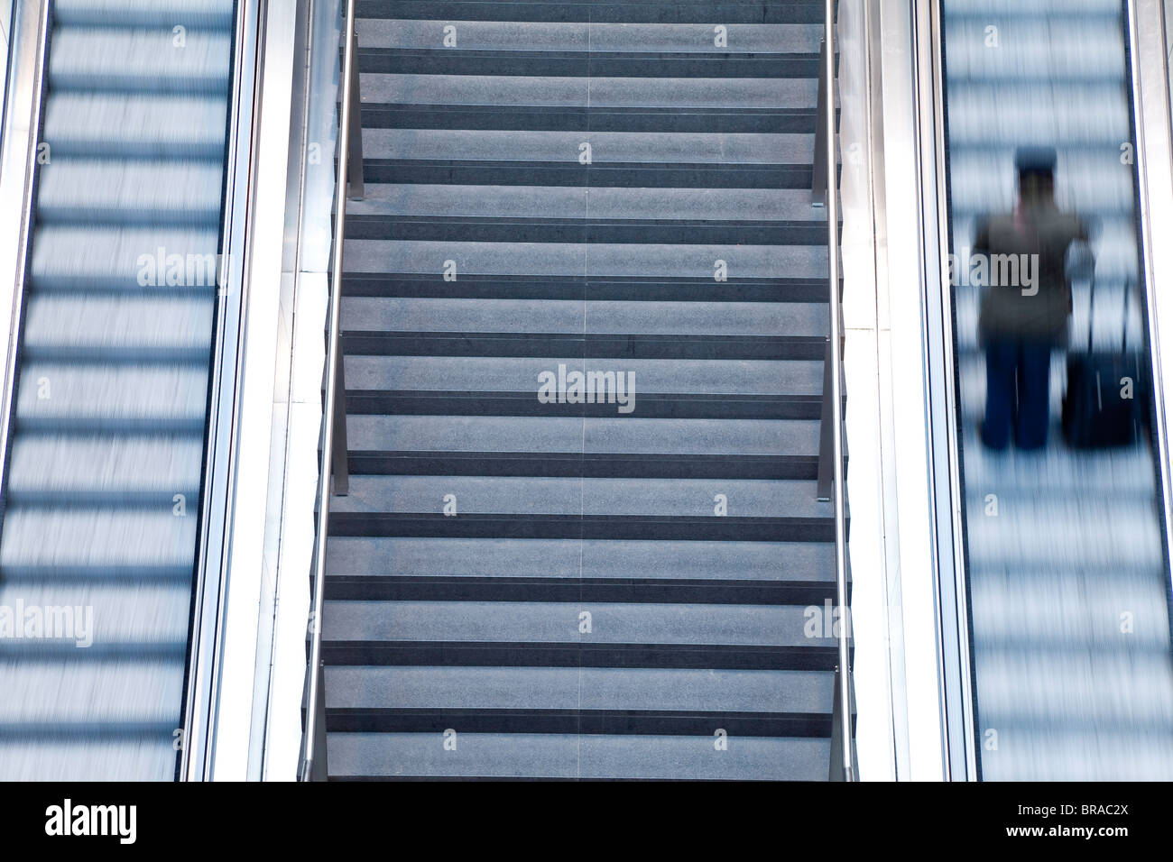 Escalator and stairs leading to the platform at modern train station ...