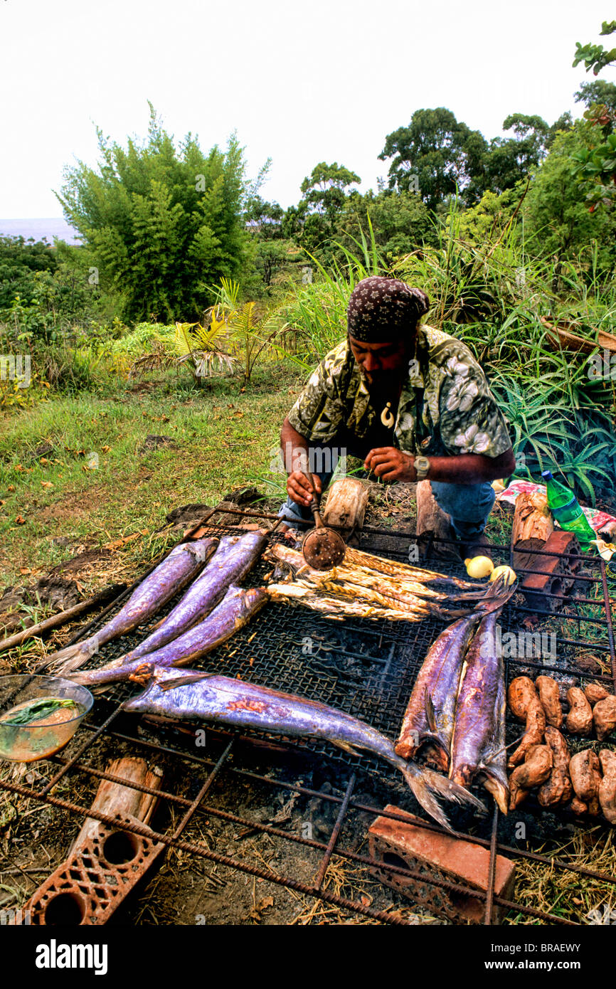 Native man cooking fish on grill Easter Island during Tapati Festival ...