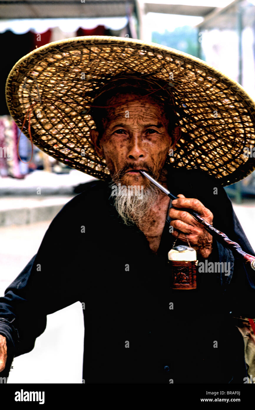 Colorful portrait of old Chinese man smoking a pipe in Yangshou China ...
