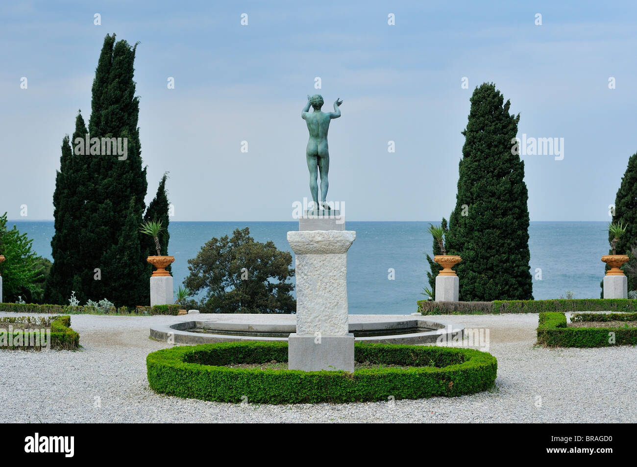 Trieste. Italy. Statue with arms outstretched to sea in the garden of ...
