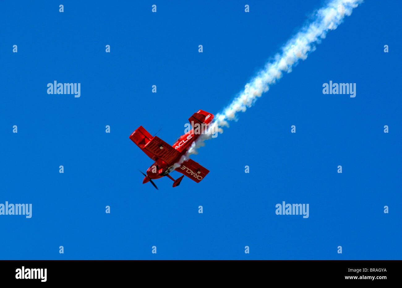 Sean Tucker flies his bright Orange Oracle Challenger through the blue ...