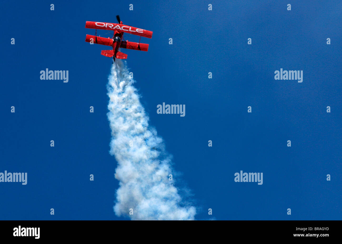 Sean Tucker flies his bright Orange Oracle Challenger through the blue ...