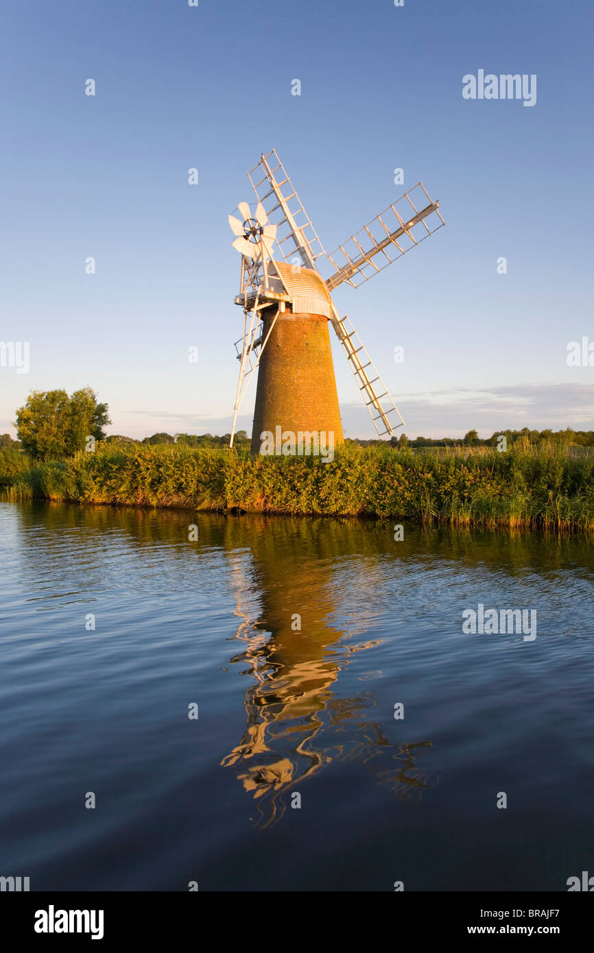 Turf Fen windmill reflected in the River Ant at sunrise, Norfolk Broads ...