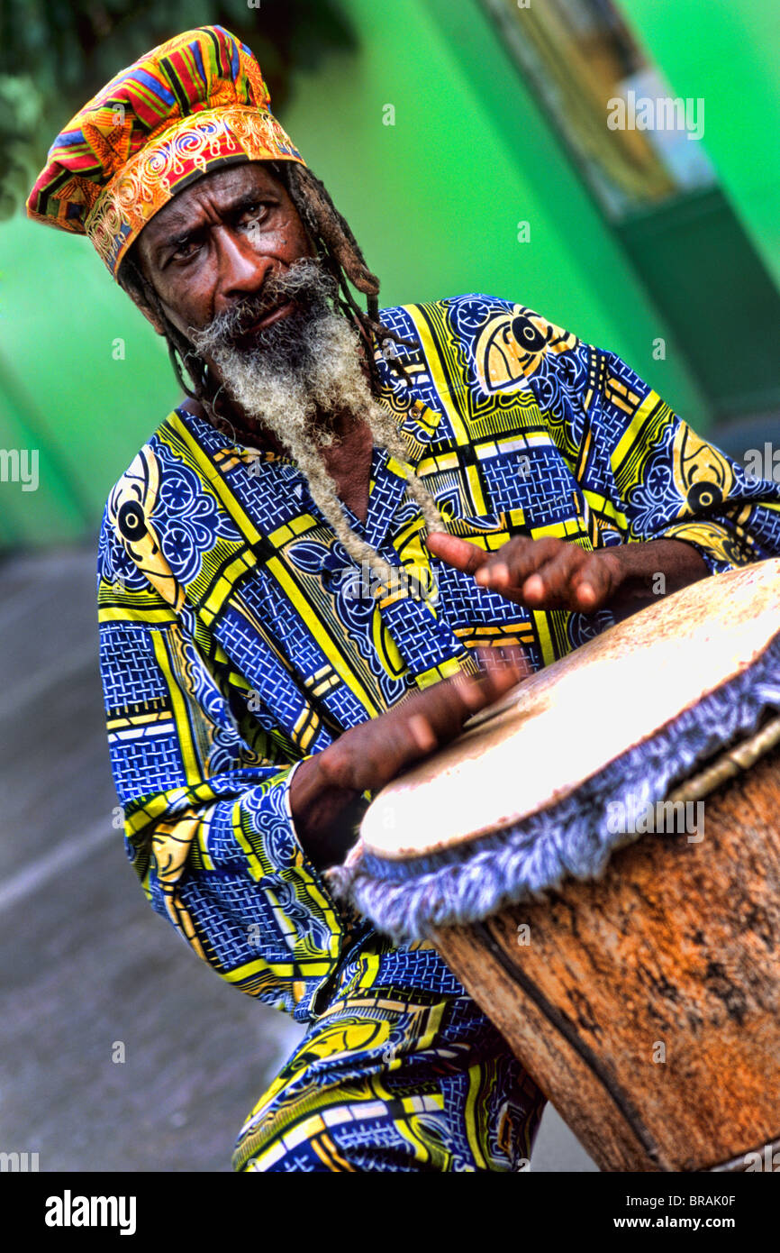 Colorful Rasta Jamaican Reggae performer on drum in costume at Harbour ...