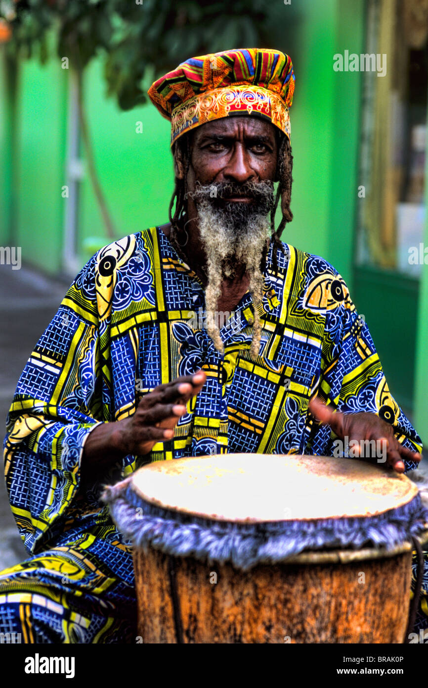 Colorful Rasta Jamaican Reggae performer on drum in costume at Harbour ...