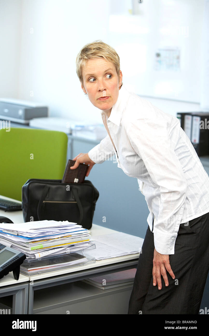 Woman stealing money in the office Stock Photo, Royalty Free Image ...