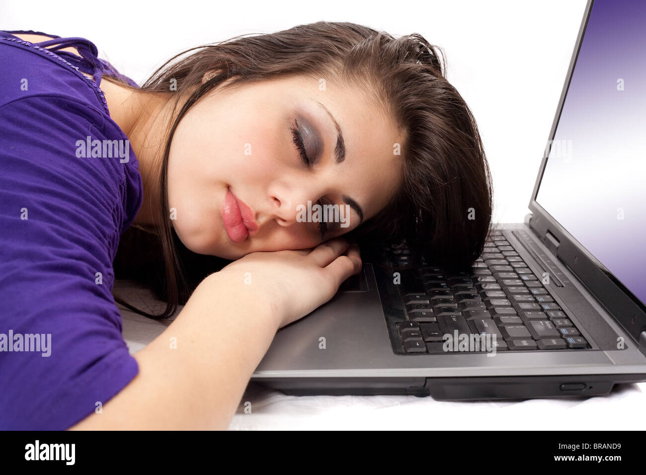 Portrait of a tired brunette sleeping on her laptop Stock Photo - Alamy