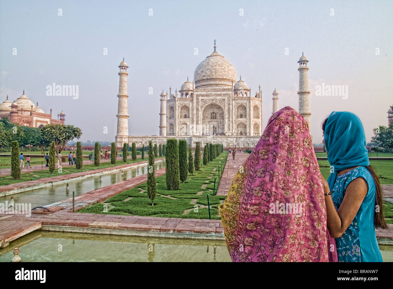 Hindu women with colorful veils in the quiet peaceful Taj Mahal one of ...