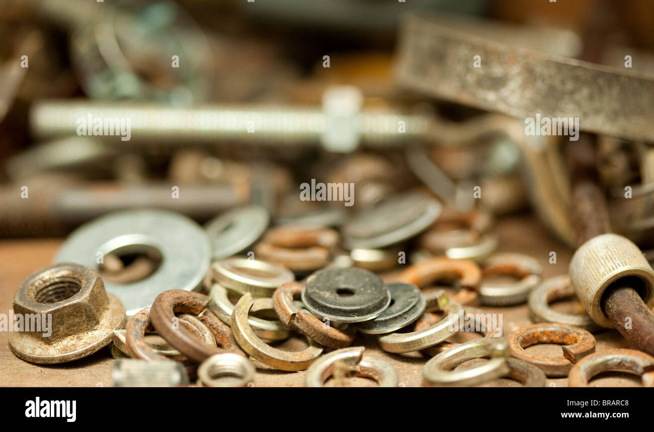 Close up of rusty nuts, bolts and metal tools with shallow depth of ...