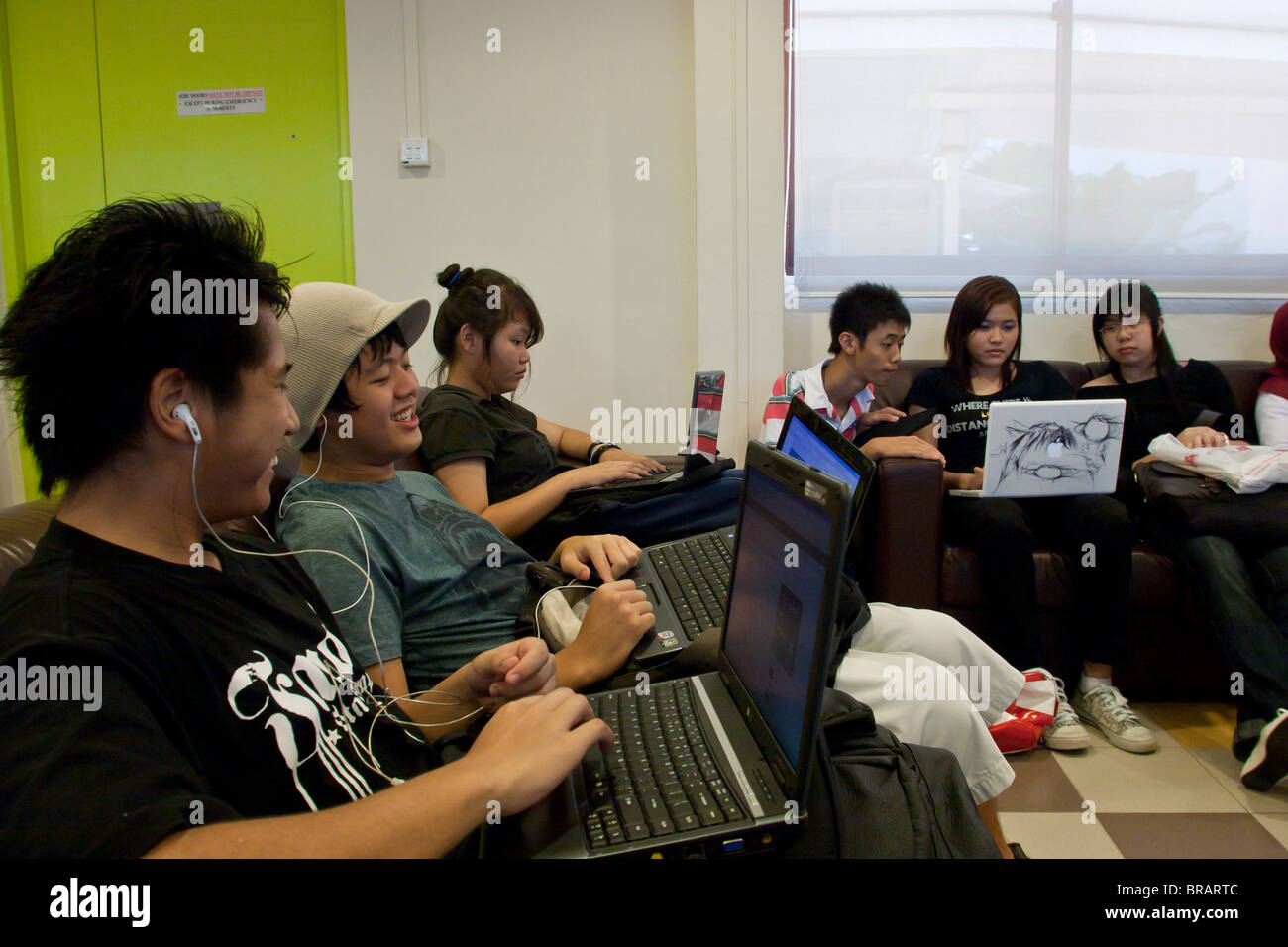 Students surf the internet on their laptops at the Singapore ...