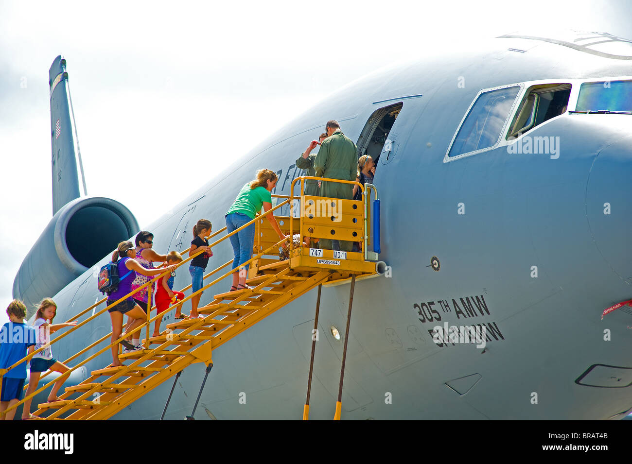 static display of KC-10 Extender, people climbing to get inside ...