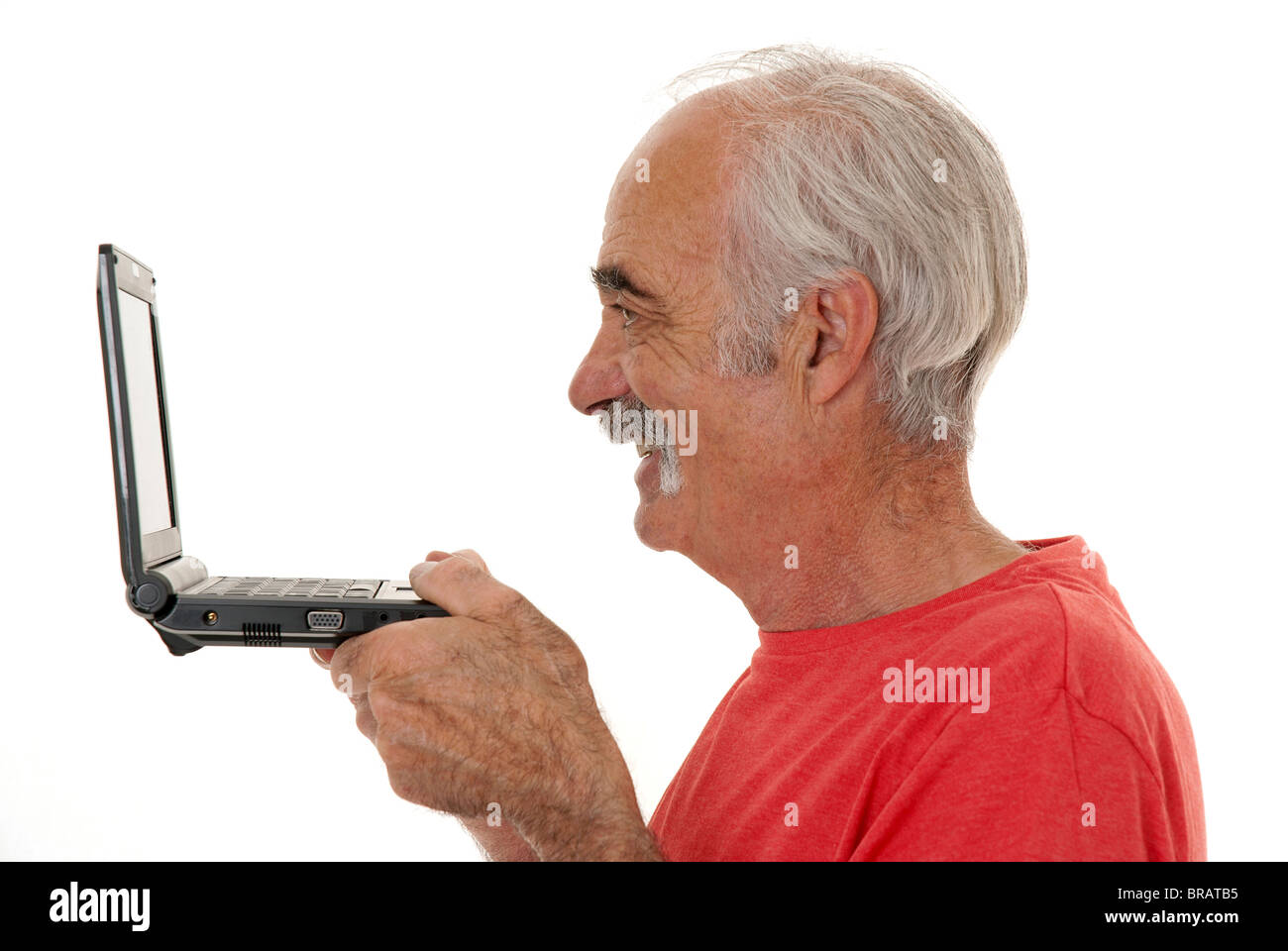 Elderly man holding a small laptop Stock Photo - Alamy