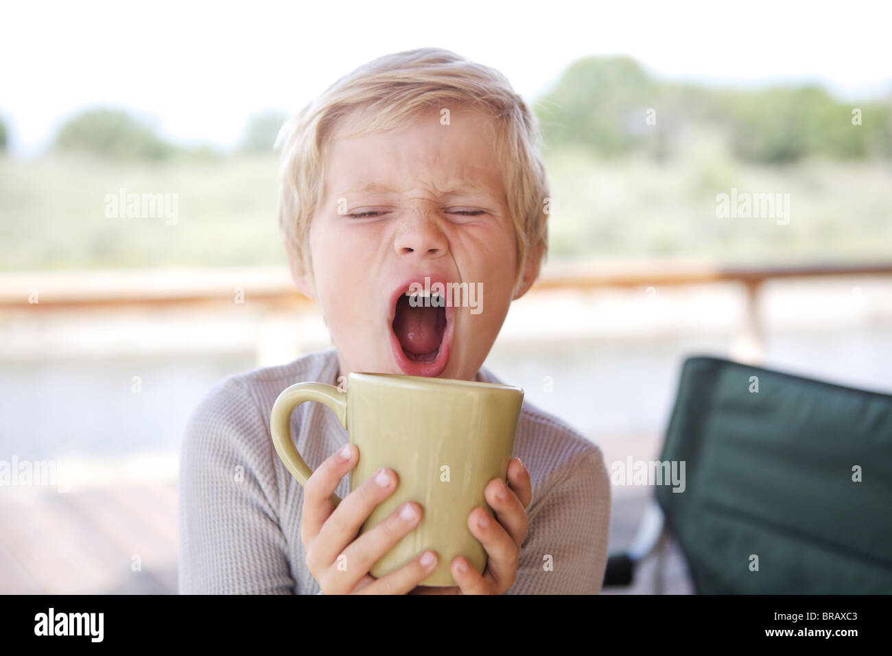 Young boy drinking from a coffee mug Stock Photo - Alamy