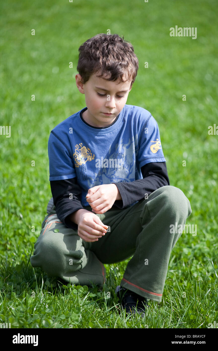 Portrait of a beautiful little boy in a grass field Stock Photo - Alamy