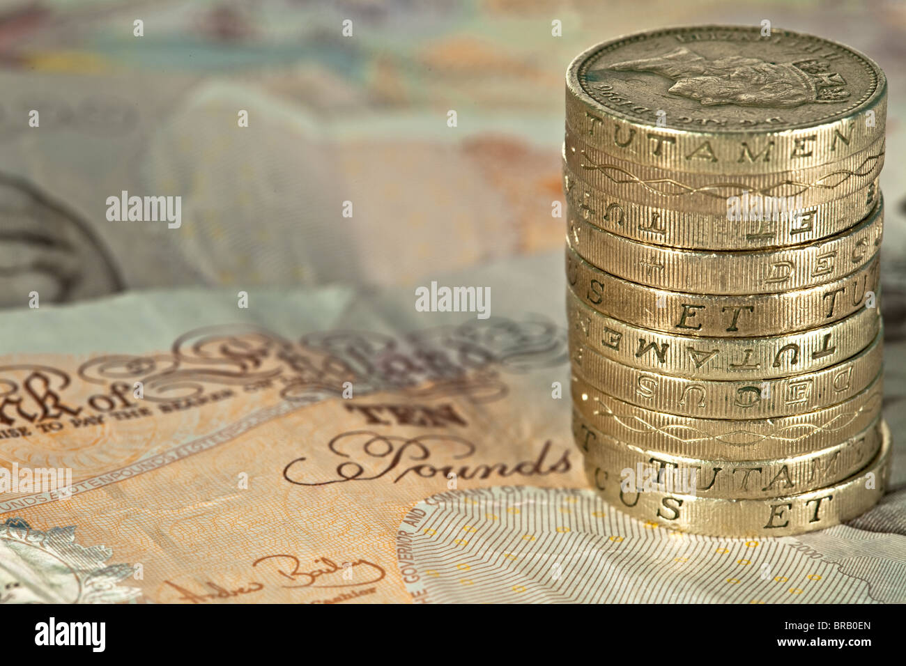 A pile of British pound coins on ten pound notes Stock Photo - Alamy