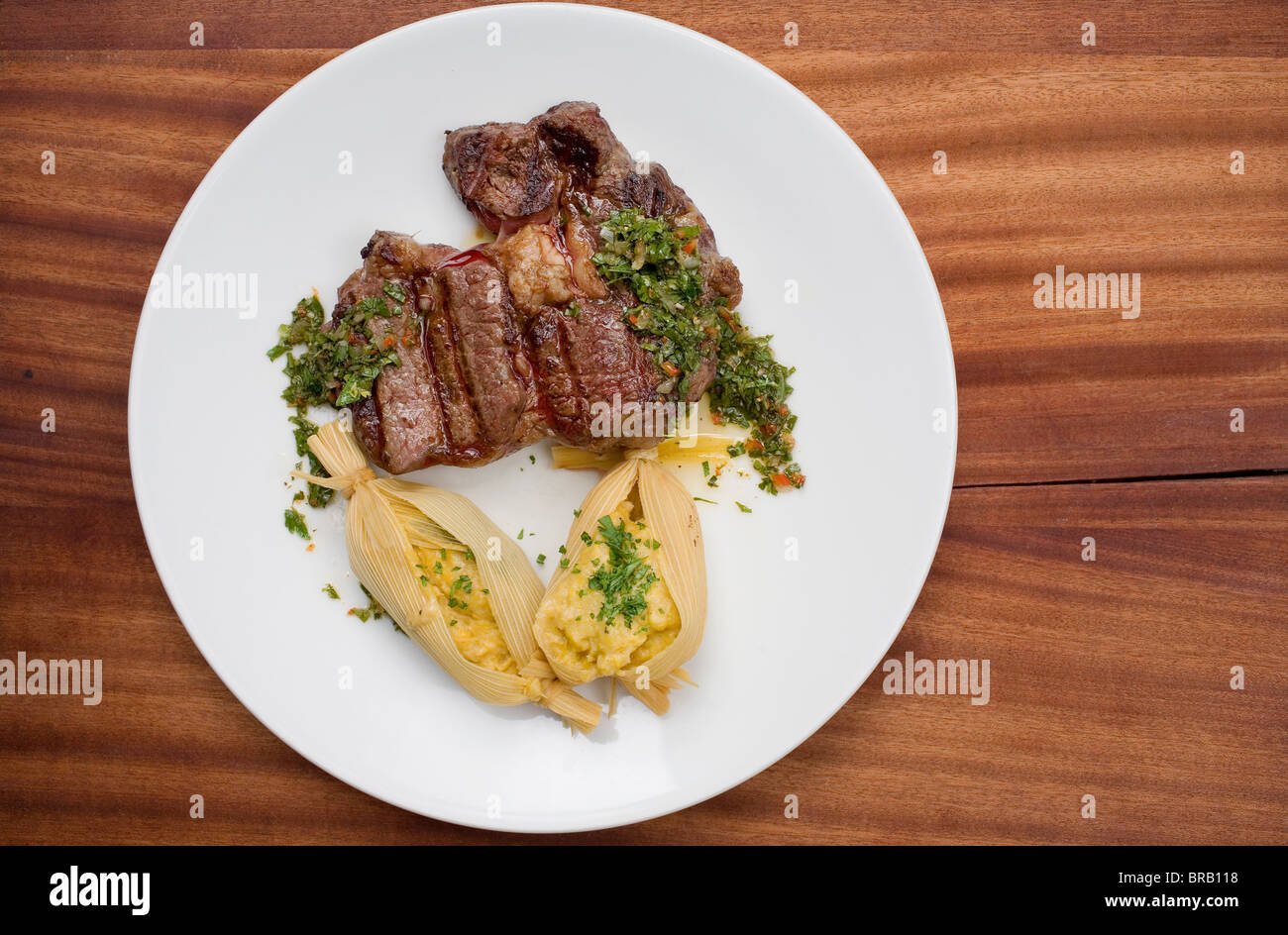 A plate of steak and sweet corn parcel viewed from above Stock Photo ...