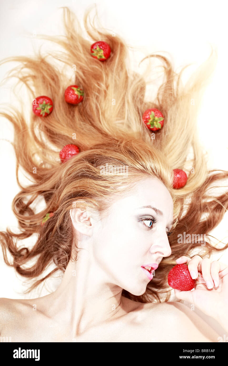 beautiful fair woman with silver makeup eating strawberries Stock Photo ...