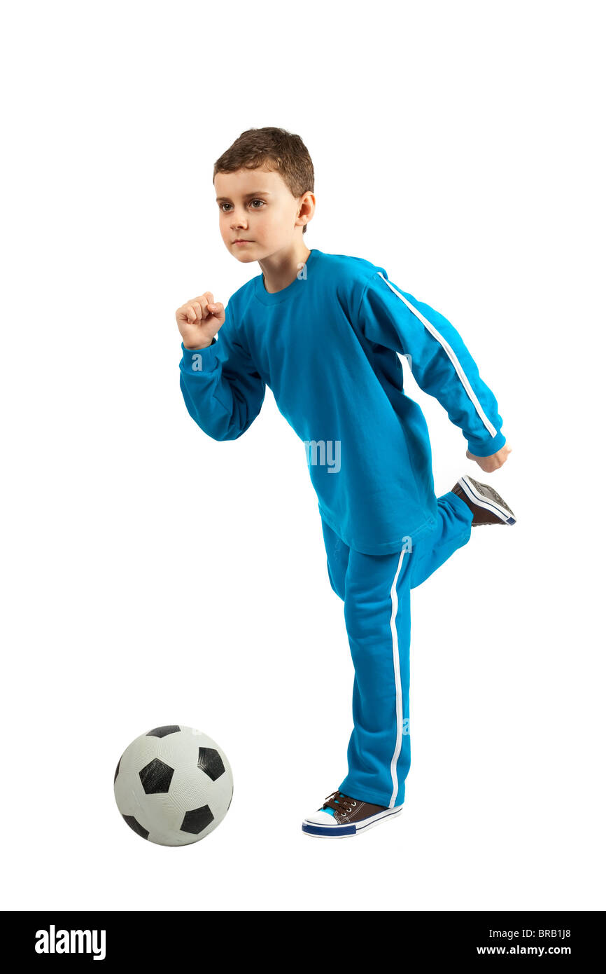 Adorable football kid executing a kick, isolated on white background ...