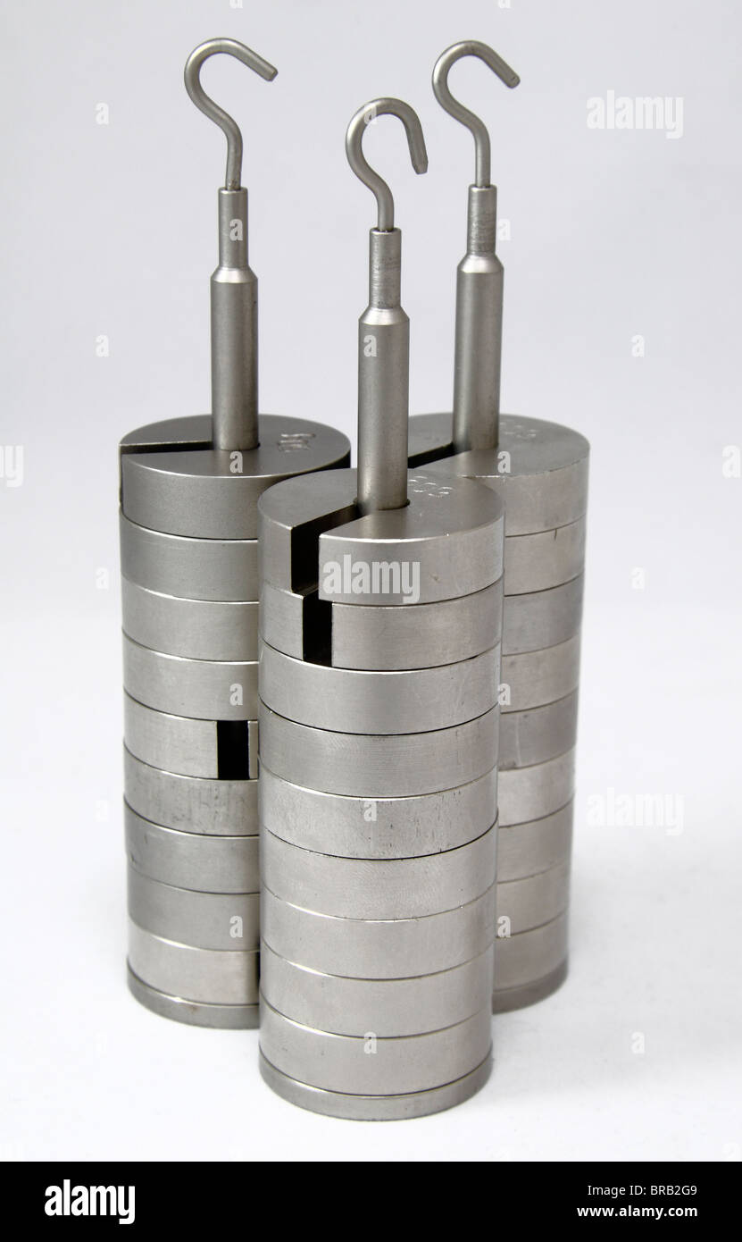 Three 50g slotted weights on hooked cradles, as used in a UK school ...