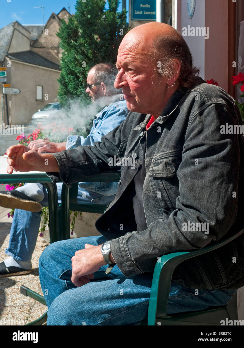 Man smoking at table outside bar - France Stock Photo - Alamy