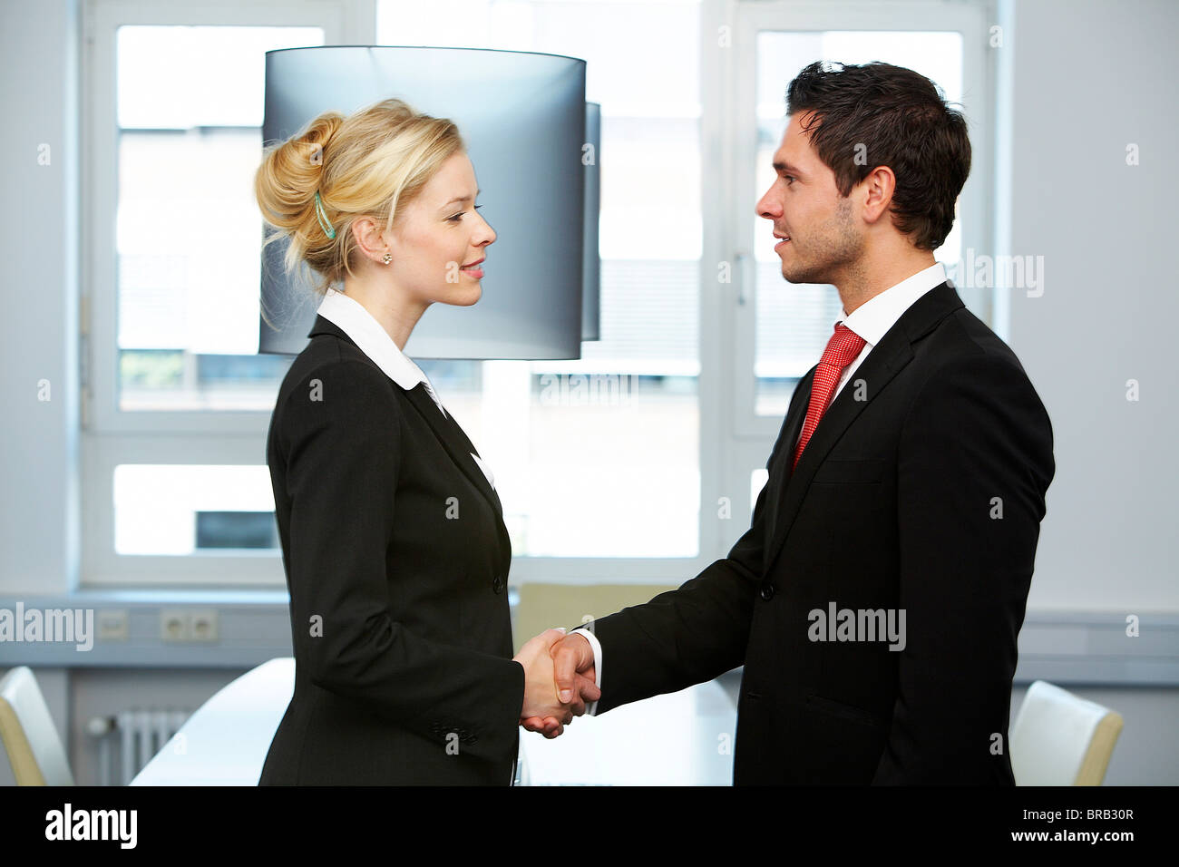 Man woman shake hands reception hi-res stock photography and images - Alamy